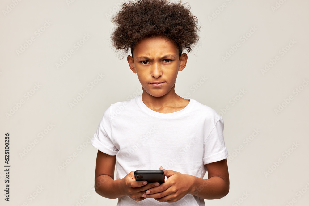 Portrait of angry frustrated boy kid with afro hairstyle dressed in ...