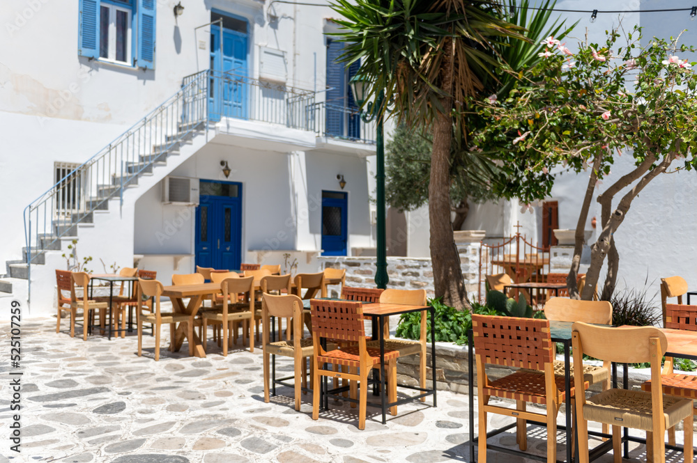 City centre and streets of village of Tinos with Cycladic houses, cafe ...