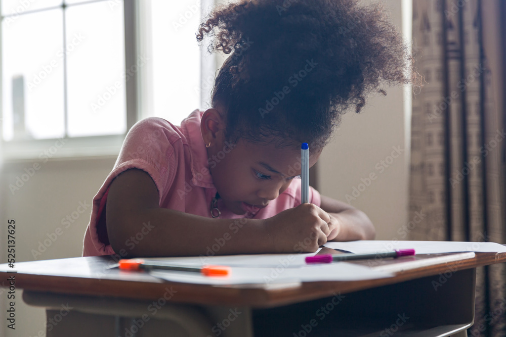 Foto de Girl is doing homework in the Classroom. Back to school! Cute ...