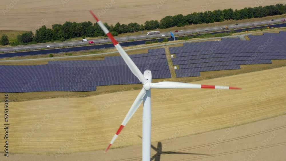 Solar panel cells and rotating wind turbines on the green energy farm ...