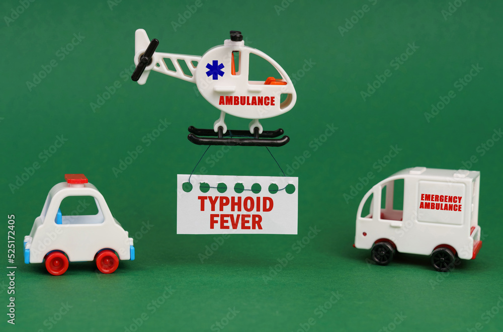 On a green surface, cars and an ambulance helicopter with a sign ...