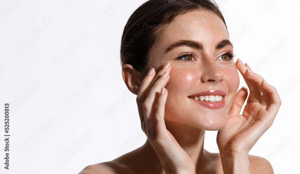 Beauty and skin care. Smiling girl cleansing her skin, rubbing in ...