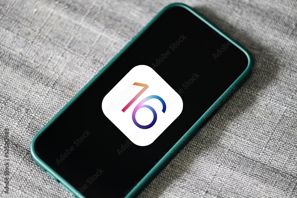 iPhone with iOS 16 logo on the screen close up, new operating system ...