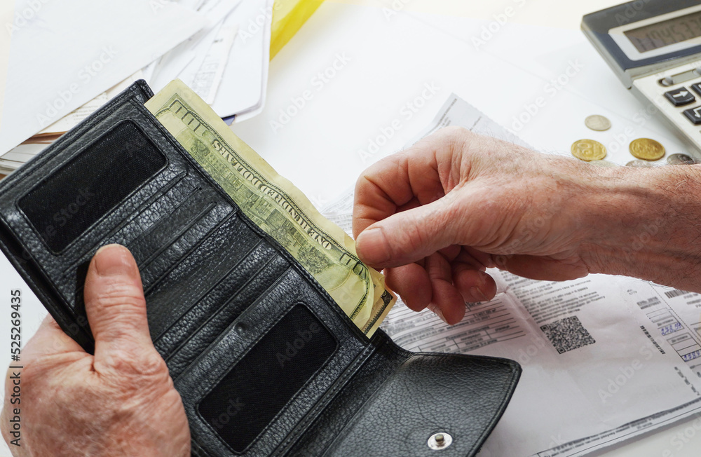 Hands of Senior man sitting at the table and calculating finances. Old ...