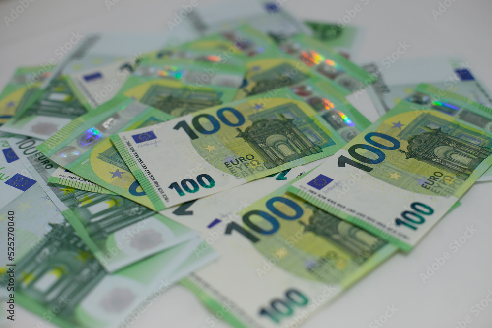 100 euro money banknotes on white surface. Multiple one hundred euro ...