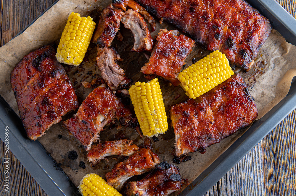 Marinated ribs with corn on the cop on a baking tray Stock Photo ...