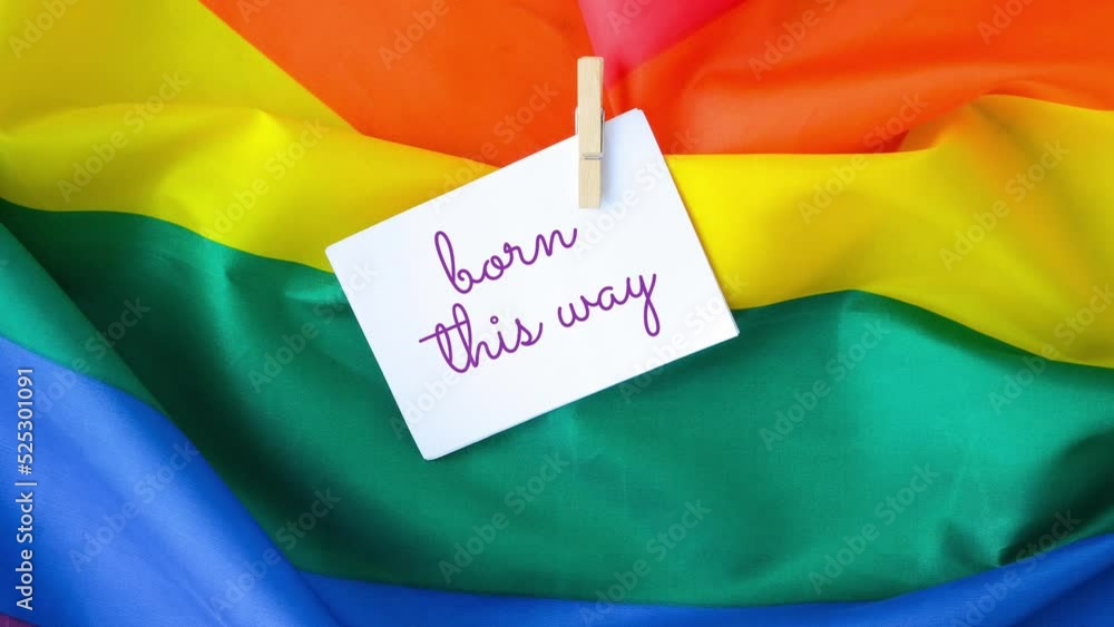 4k zoom in out Rainbow flag with text BORN THIS WAY message on paper ...