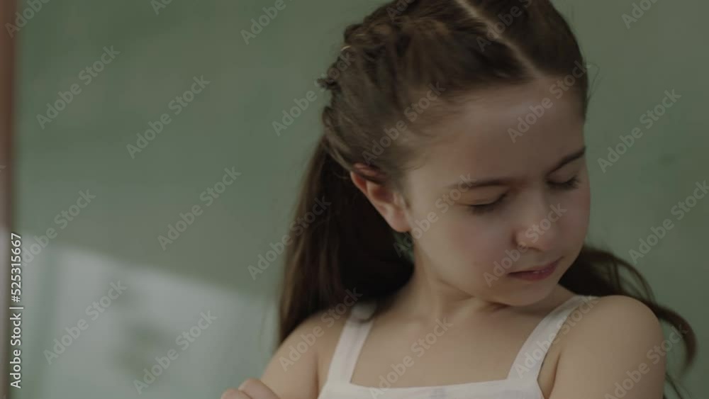 Sad girl in front of blackboard at school. The unhappy face of the girl ...