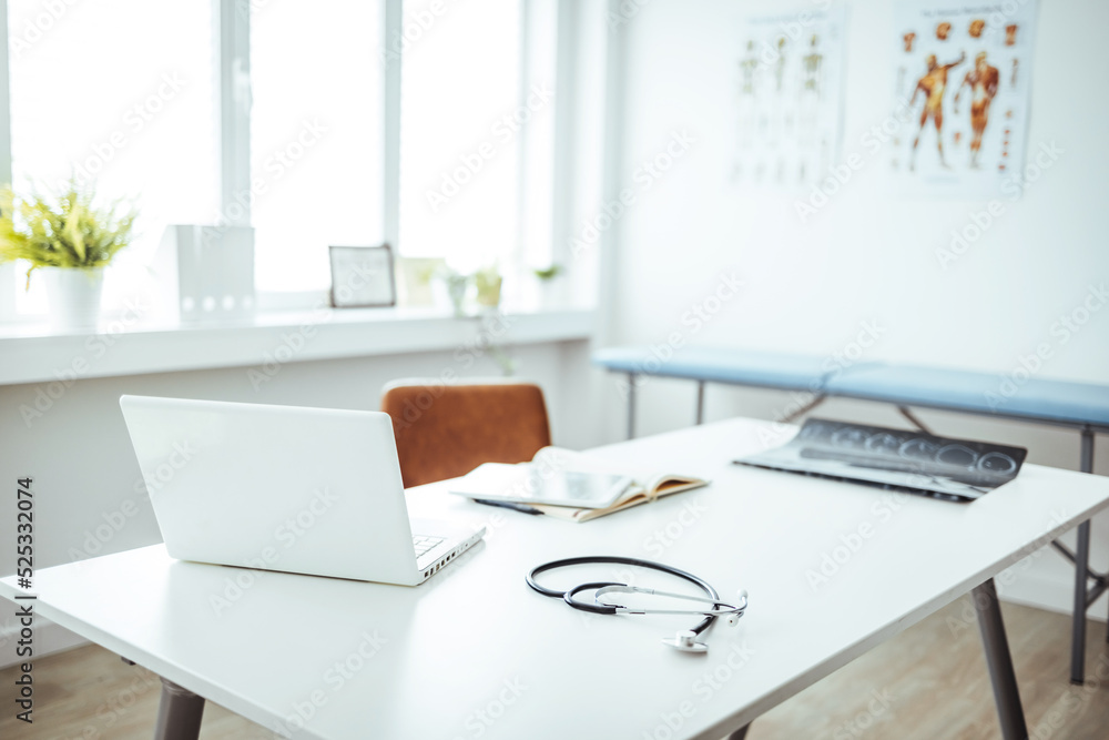 Interior of empty pediatrician office with bed and computer. Doctor's ...