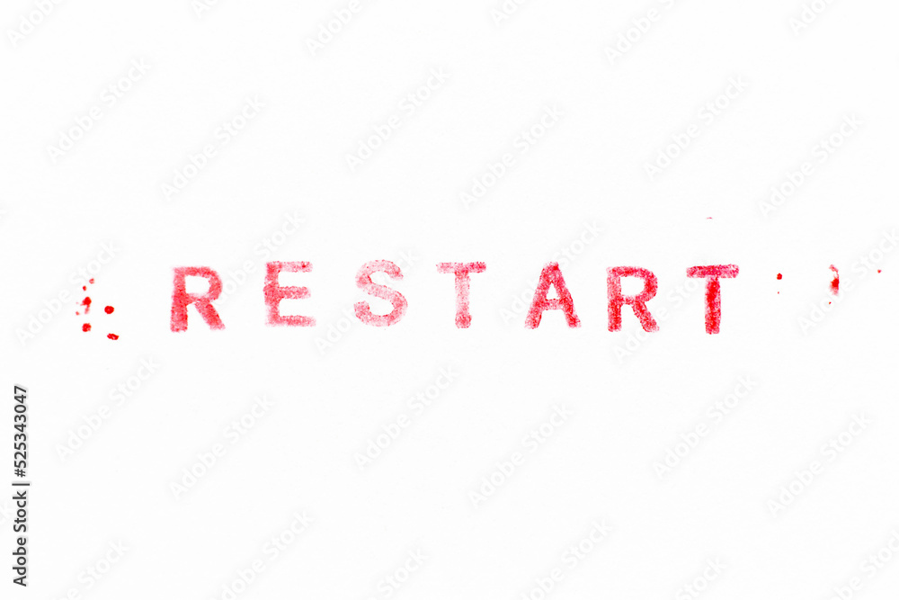 Red color ink rubber stamp in word restart on white paper background ...