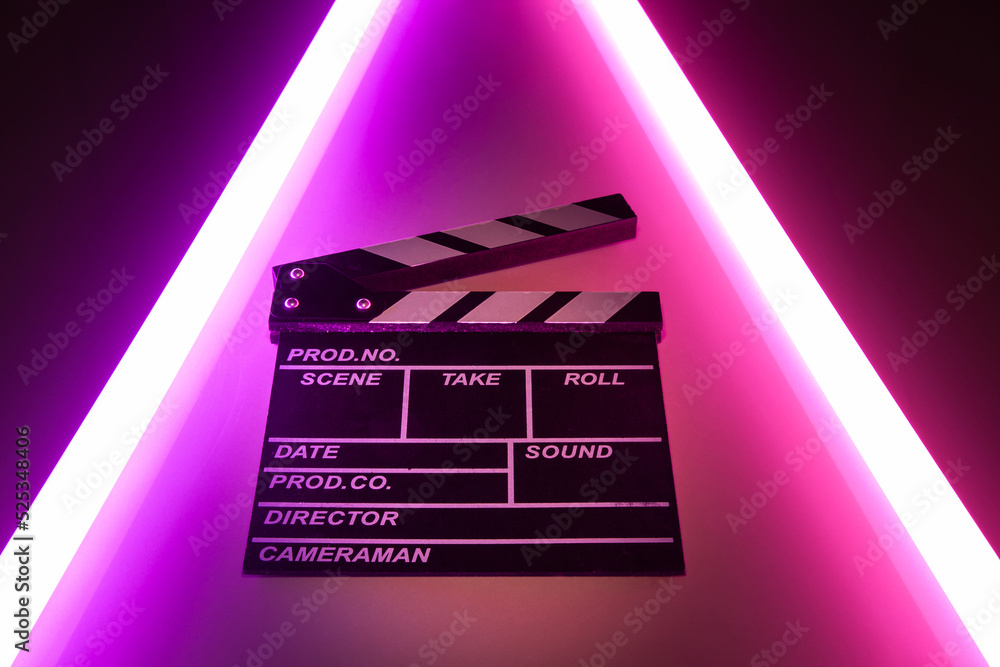 Clapperboard movie slate on Glowing neon lighting background. video ...