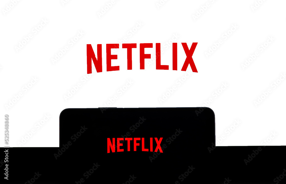 Netflix logo on smartphone screen and Netflix logo on computer ...