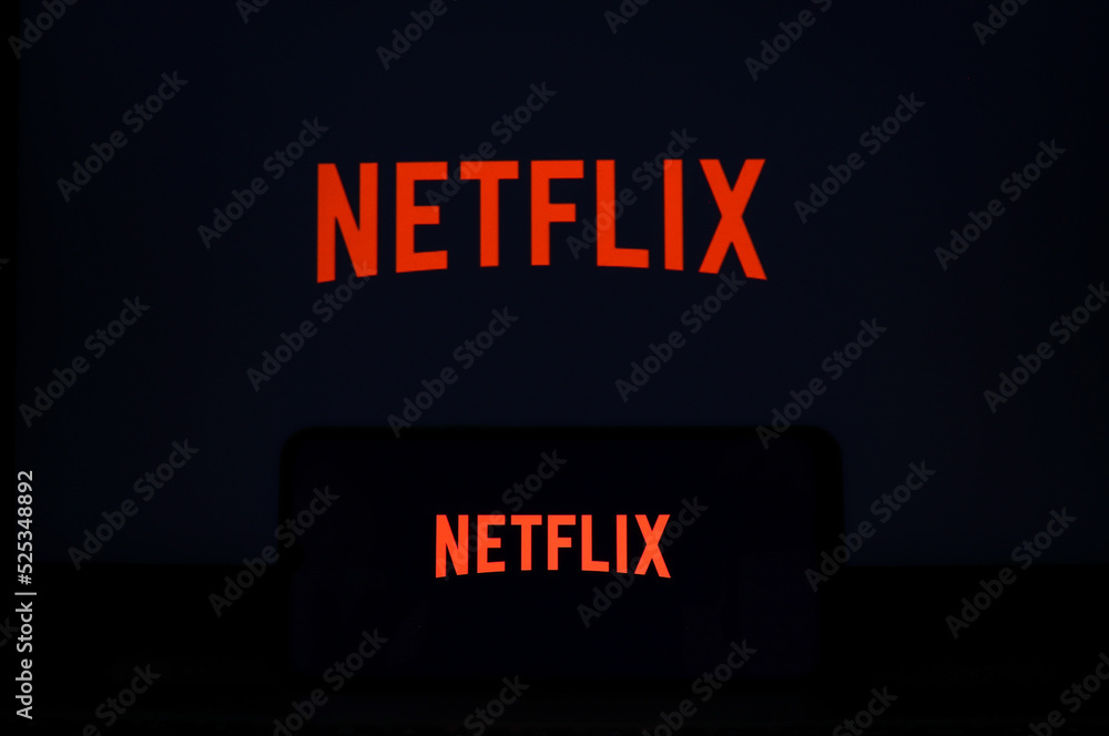Netflix logo on smartphone screen and Netflix logo on computer ...