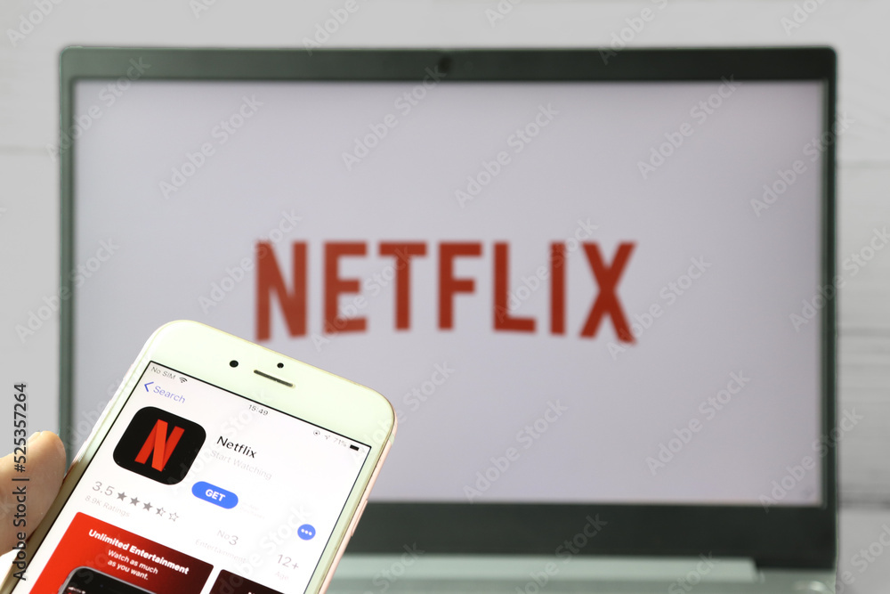 Netflix logo on computer screen and Netflix logo on smartphone screen ...