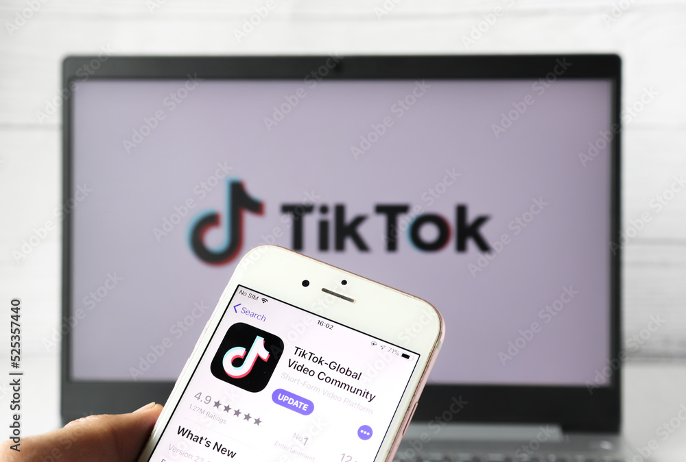 tiktok application on phone screen and tiktok logo background on ...