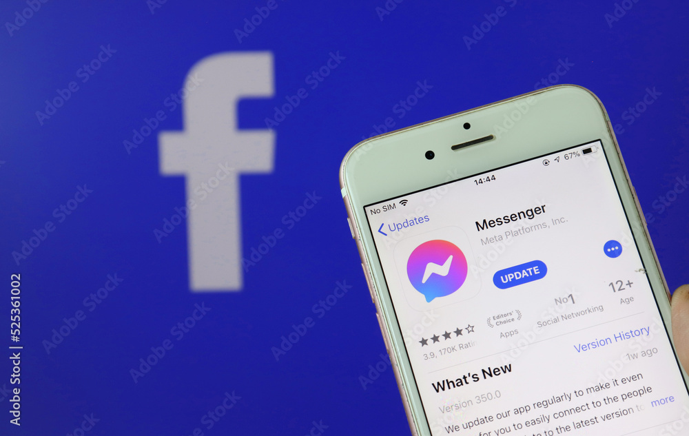 Facebook messenger logo on phone screen and Facebook logo background on ...