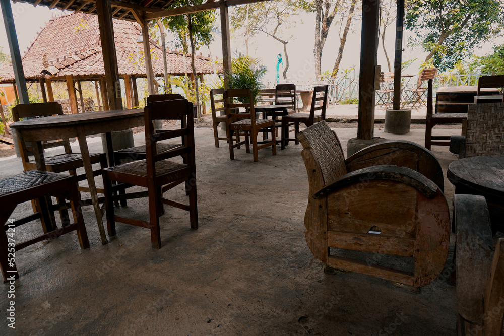 set of wooden tables and chairs in a traditional style in an old ...