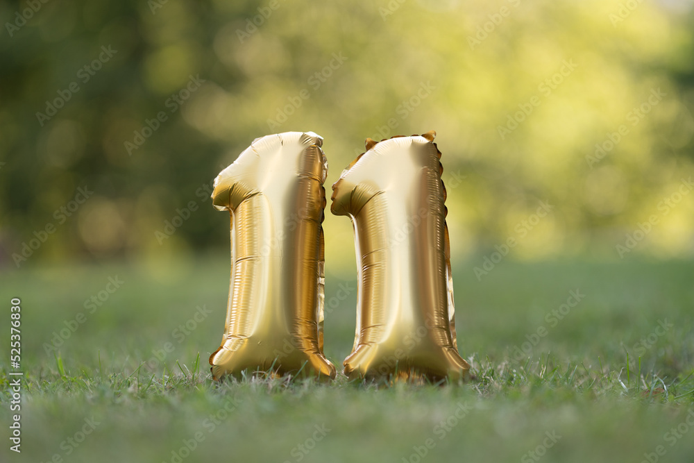 number 11 eleven from golden inflatable balloons Stock Photo | Adobe Stock