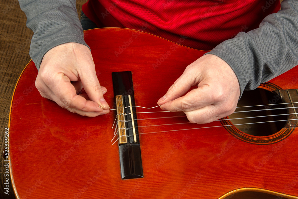 replacement and insertion of nylon strings in a classical guitar ...