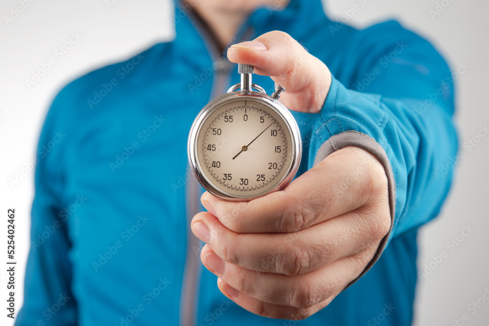 mechanical stopwatch in hand. Time part precision. Measuring the speed ...