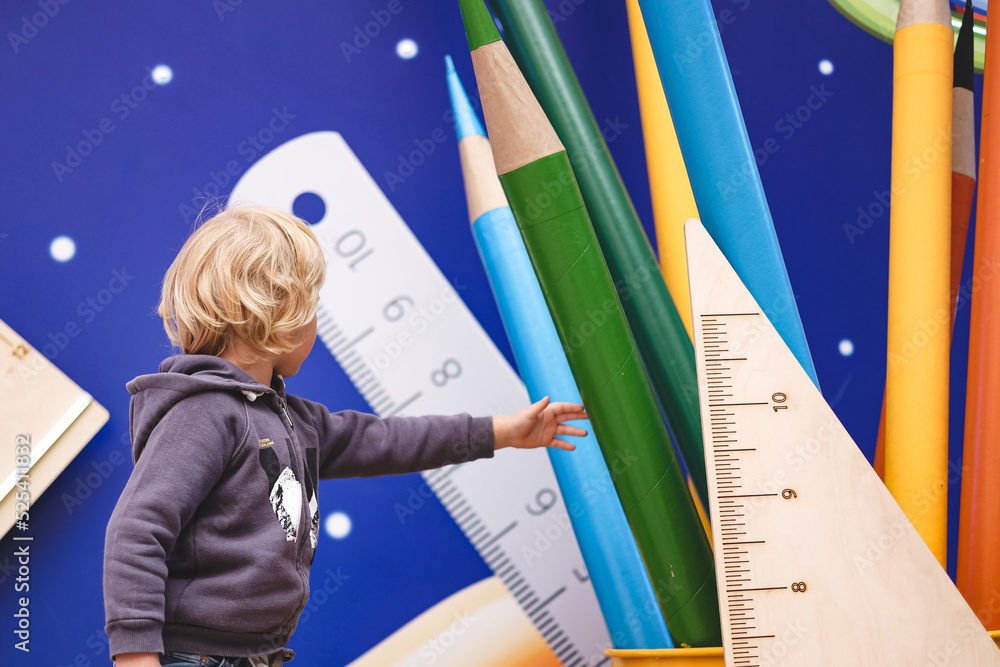 Cute boy on the colorful, bright, school background with various school ...