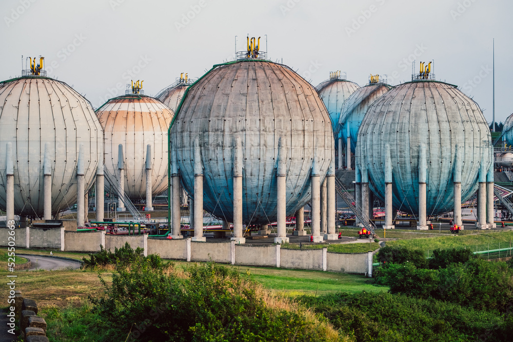 Ground environment of refinery with spherical gas tanks and trucks ...