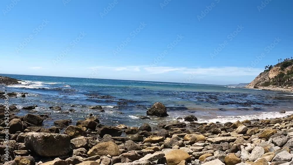 footage of a gorgeous summer landscape at the beach with blue ocean ...