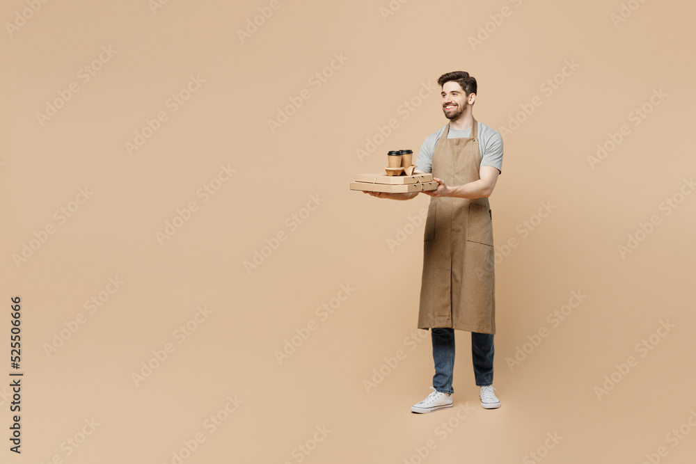 Full body young man barista barman employee wear brown apron work in ...