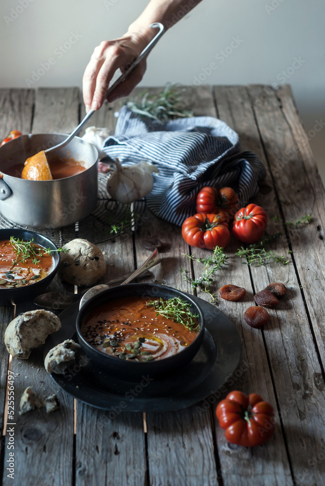 Crop person serving creamy tomato soup Stock Photo | Adobe Stock