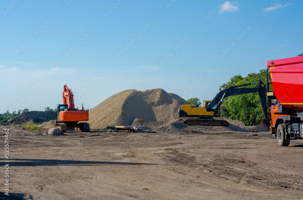Excavators for loading construction rubble. Large dump truck for cargo ...