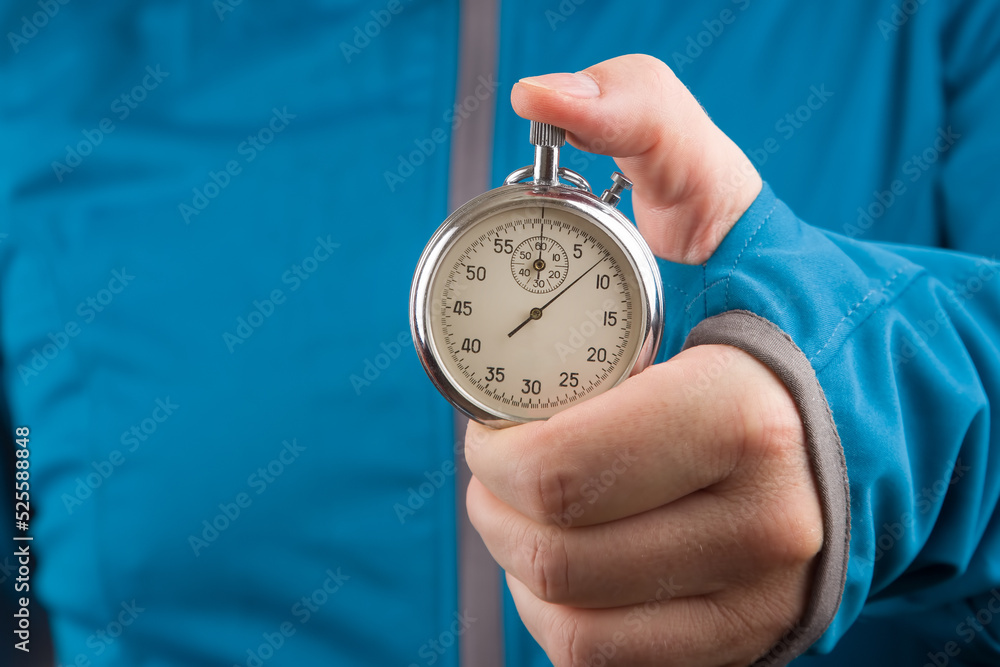 mechanical stopwatch in hand. Time part precision. Measuring the speed ...