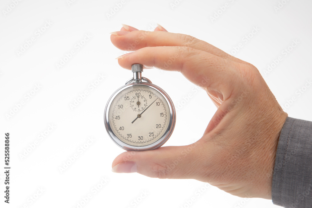 hand with a mechanical analog stopwatch on a white background. Time ...