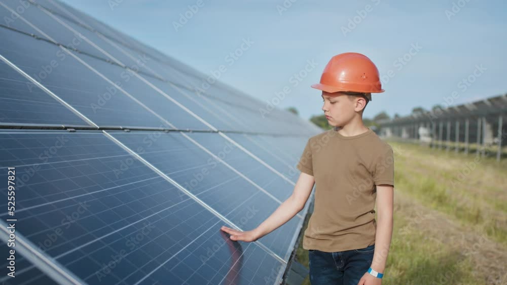 Vídeo do Stock: Portrait of a child near the solar panels. A little boy ...