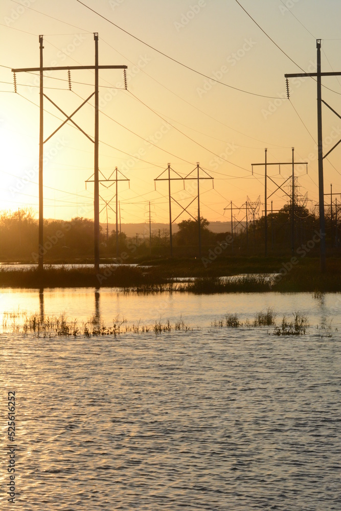 High voltage power lines running through a marsh wetland on a hot ...