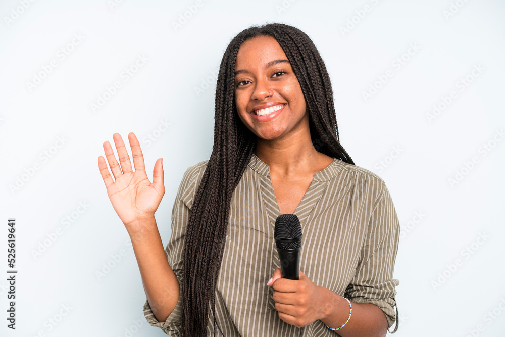 black pretty woman smiling happily, waving hand, welcoming and greeting ...