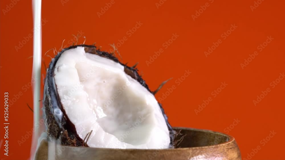 Drops of coconuts oil over red background, dripping coconut water ...