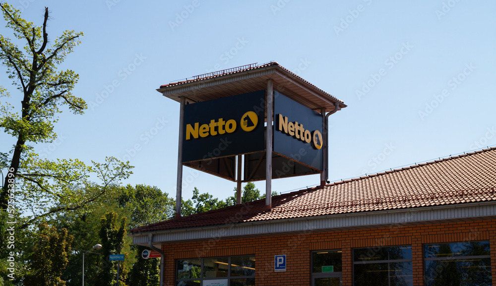 Netto shop entrance, with brand logo signboard. Danish international ...