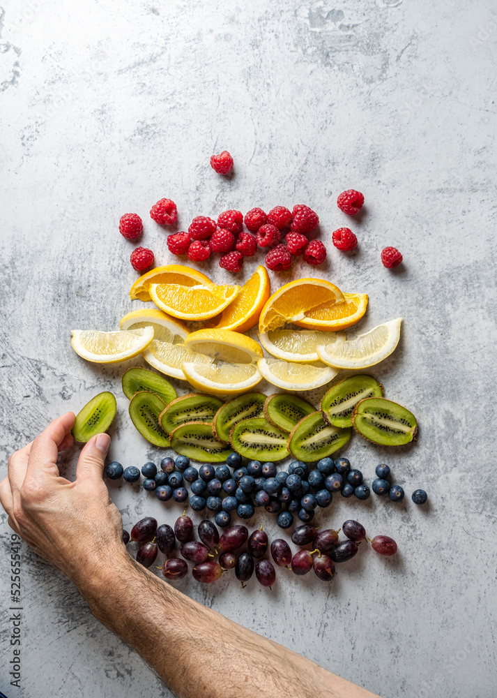 Fruit cut and arranged in the order of the colors of the rainbow. One ...