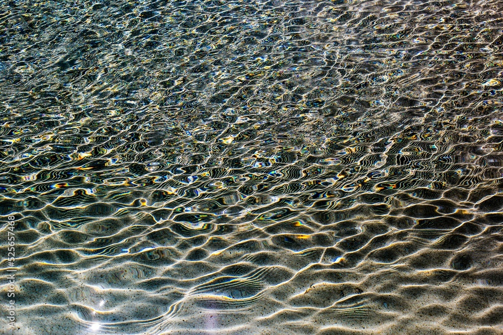 Shallow water texture, underwater view of the sandy seabed under the ...