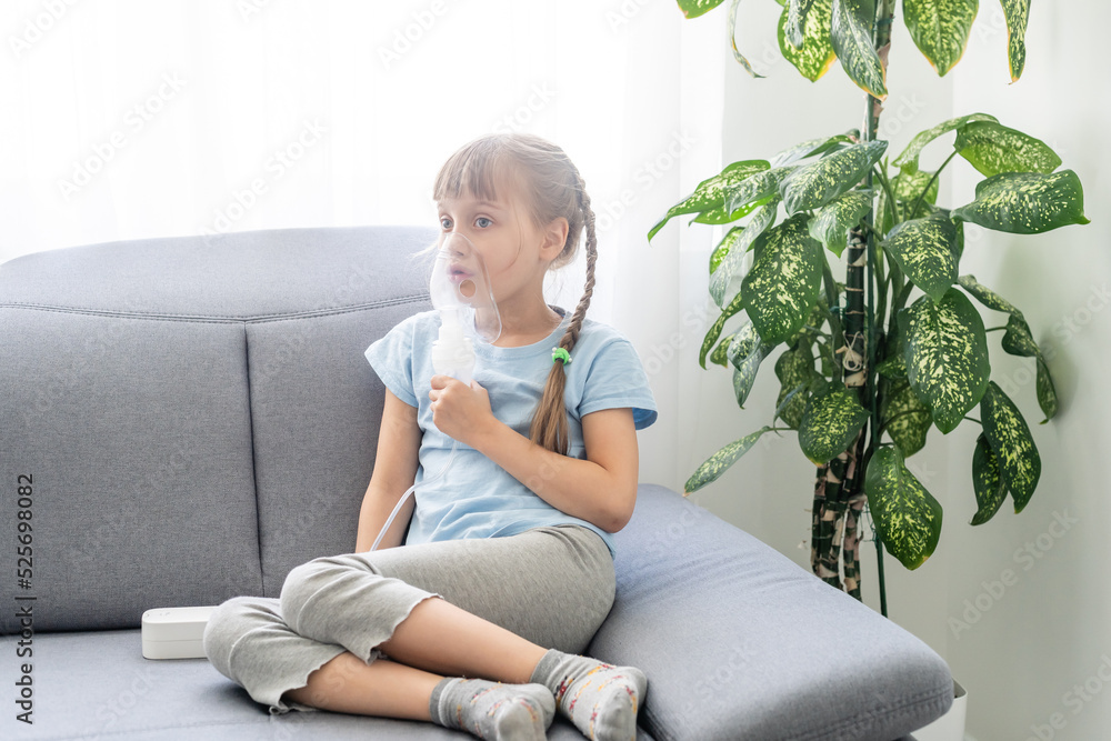 Kid girl makes inhalation with a nebulizer. sick child holding ...