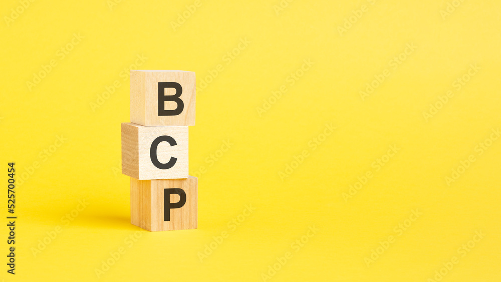 BCP - Business Continuity Plan - text on wooden block with yellow ...