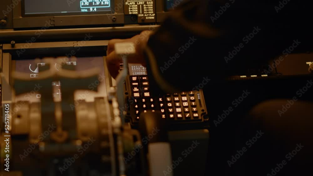 Male copilot inserting flight coordinates to arrive at destination ...