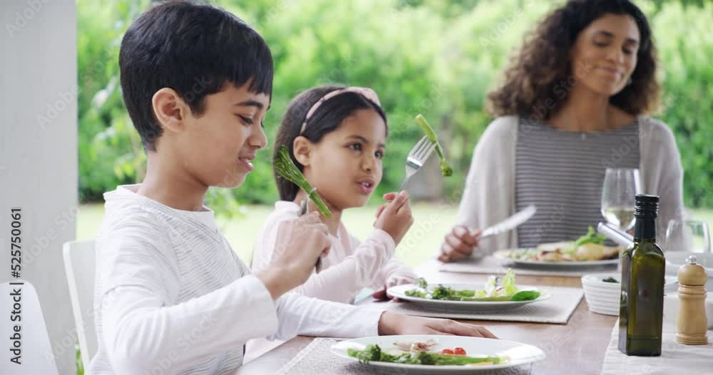 Family, lunch and children at the table with salad refusing to eat ...