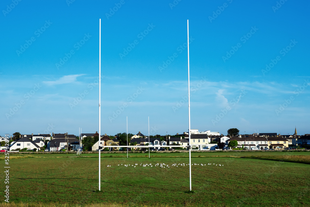 Green grass in a field and tall goal posts for Irish National sports in ...