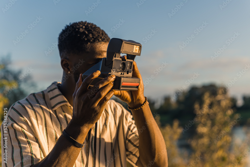 Young serene male photographer-amateur snapping photos of the ...