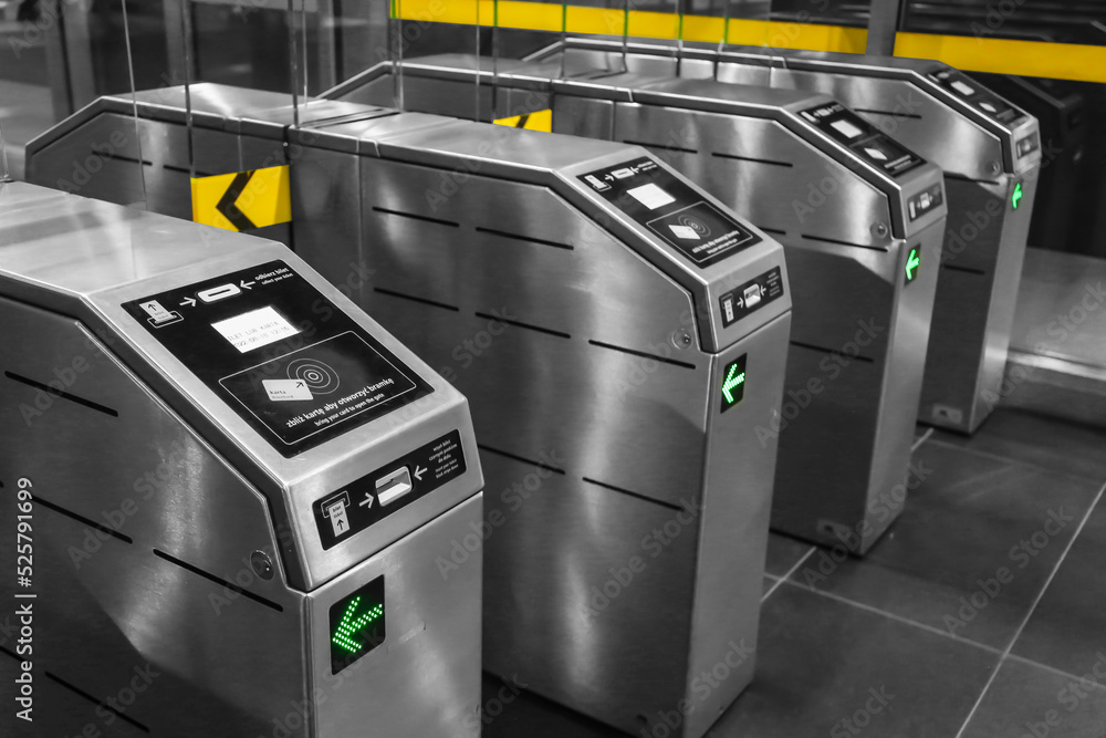 Foto de View on metro station ticket barriers with green light for ...