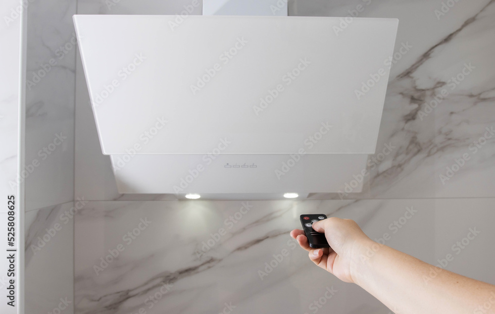 Control of a modern inclined kitchen hood with a remote control ...
