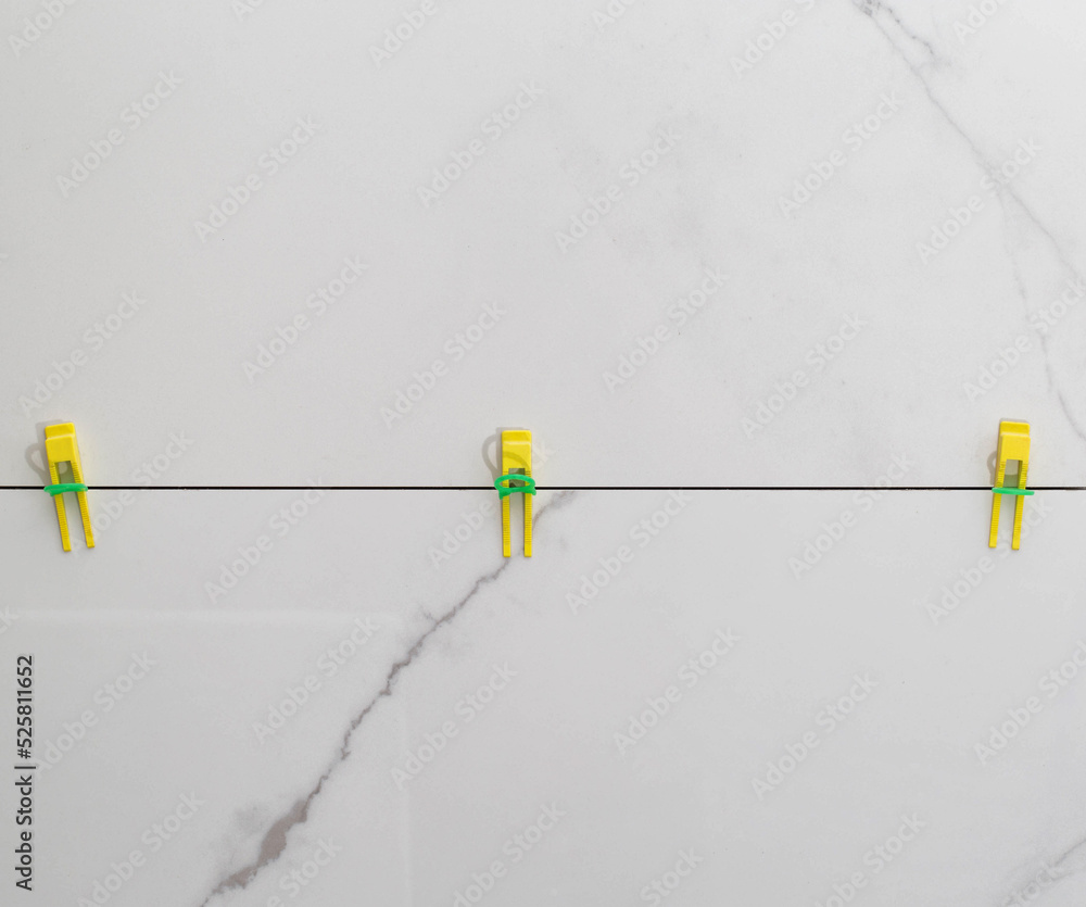 Modern system for leveling tiles during installation. Installation of ...