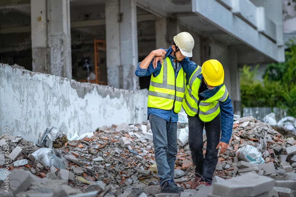 Construction supervisors or engineers help construction workers who ...