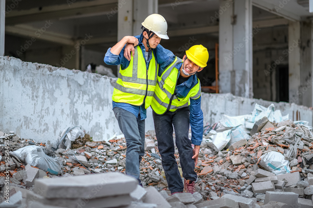 Construction supervisors or engineers help construction workers who ...